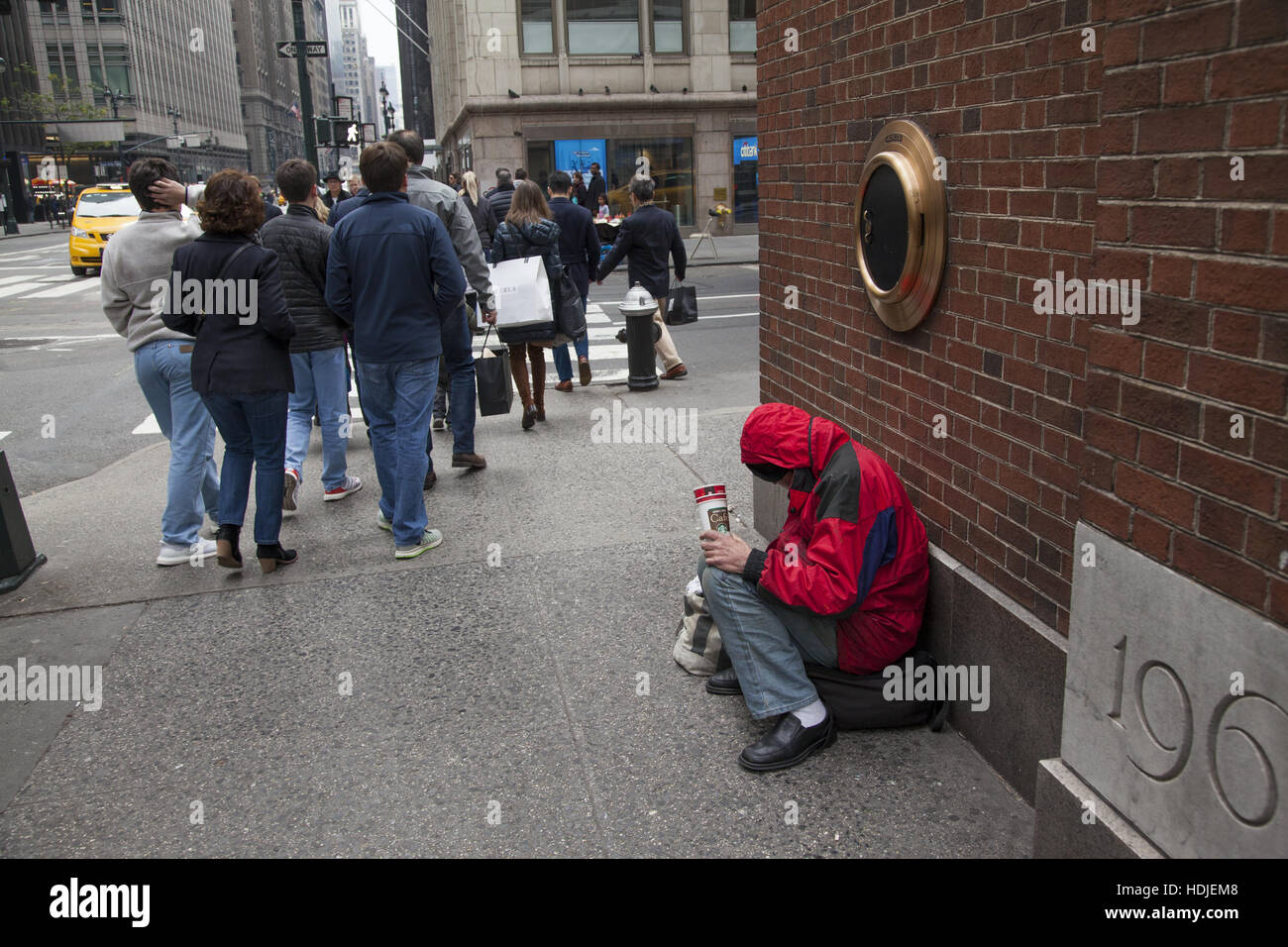 Man sitting and begging for change on the first day of the holiday gift ...