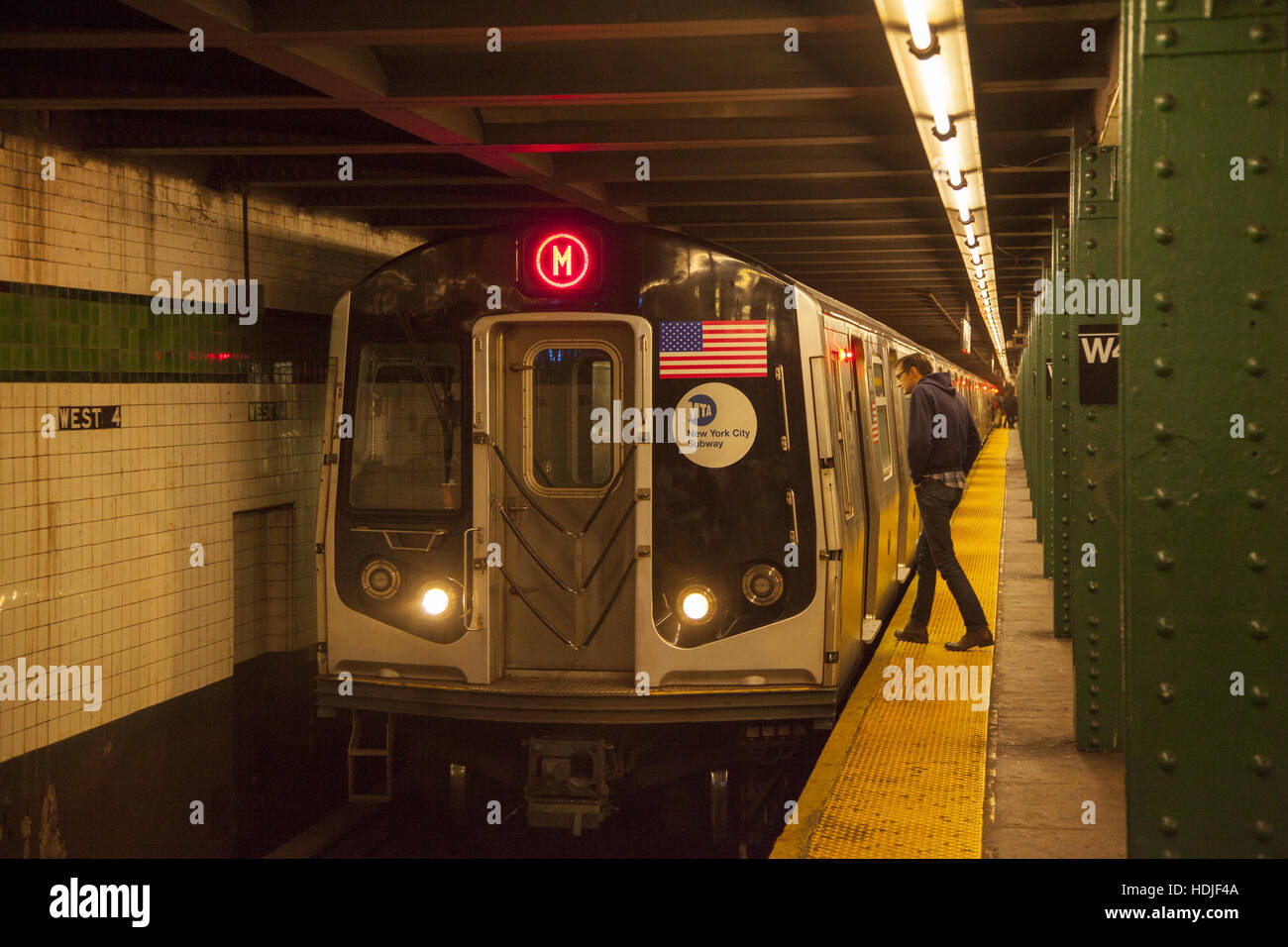 Subway train at the West 4th Street station in Greenwich Village, New York City Stock Photo - Alamy