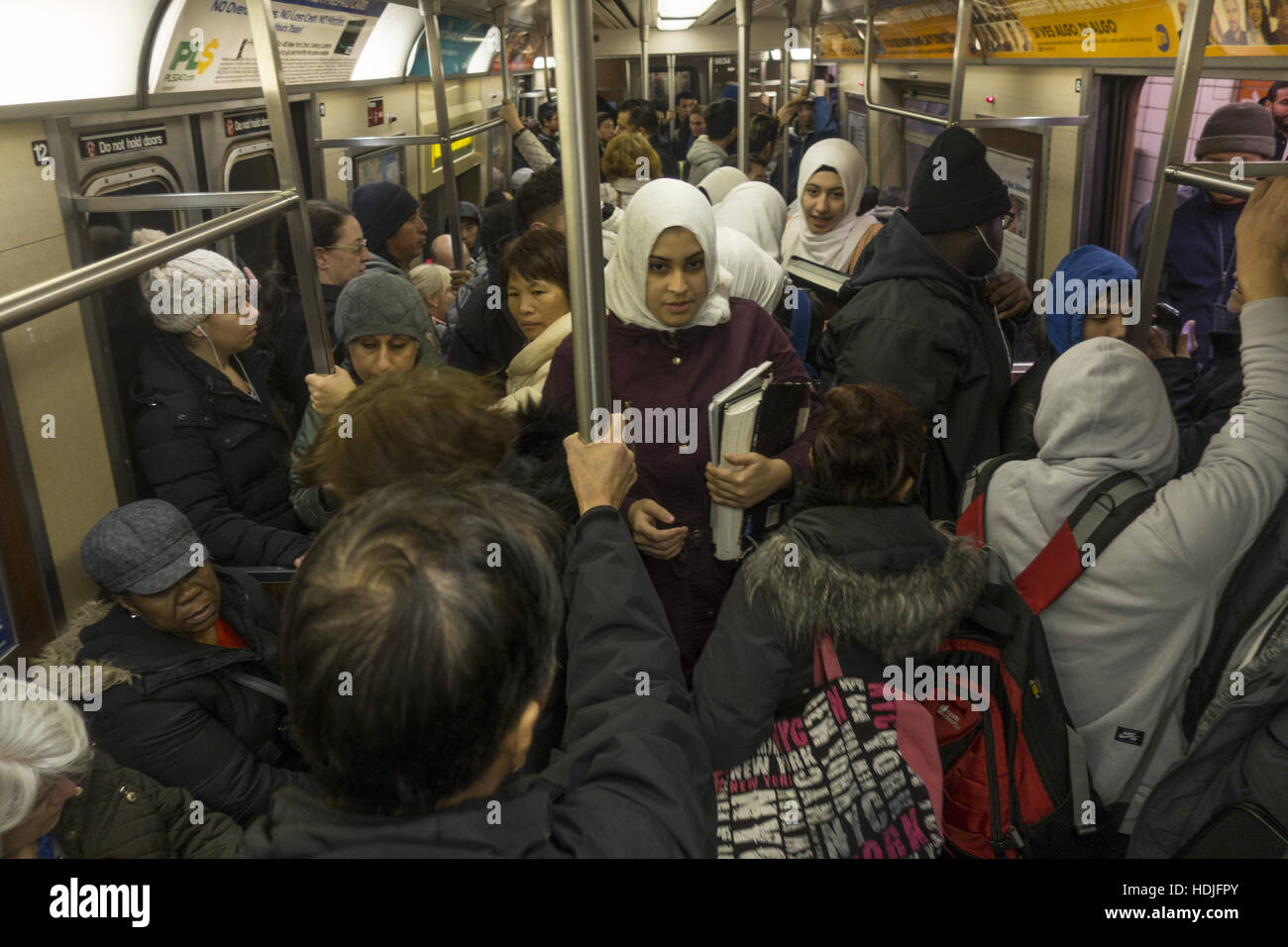 A packed R subway train filled with workers and students in Brooklyn ...