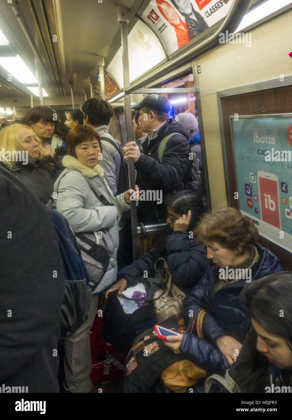 A packed R subway train filled with workers and students in Brooklyn ...