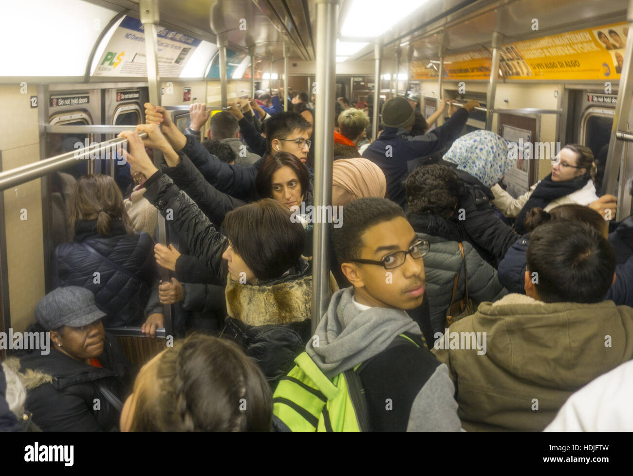 A packed R subway train filled with workers and students in Brooklyn ...