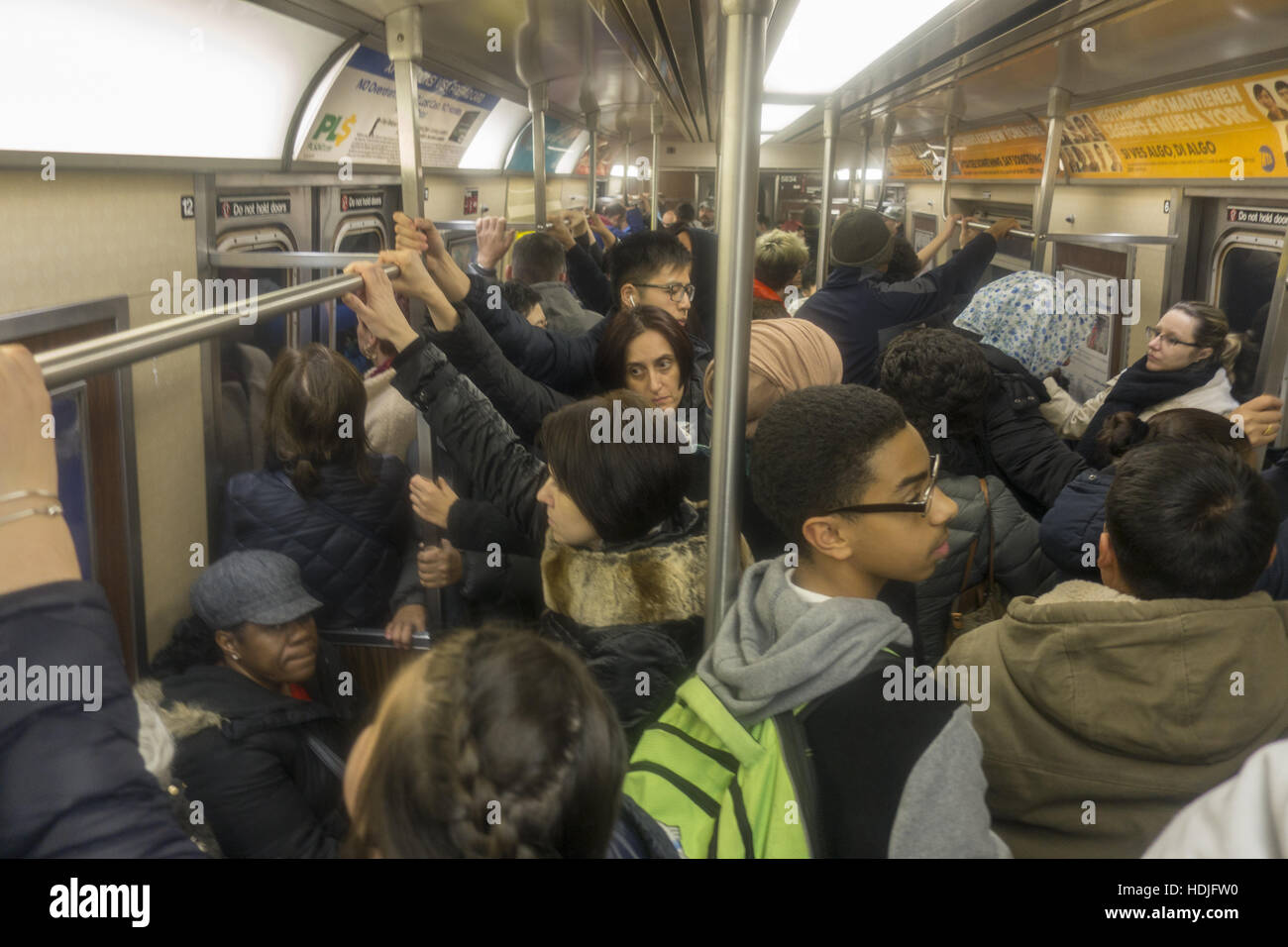 A packed R subway train filled with workers and students in Brooklyn ...