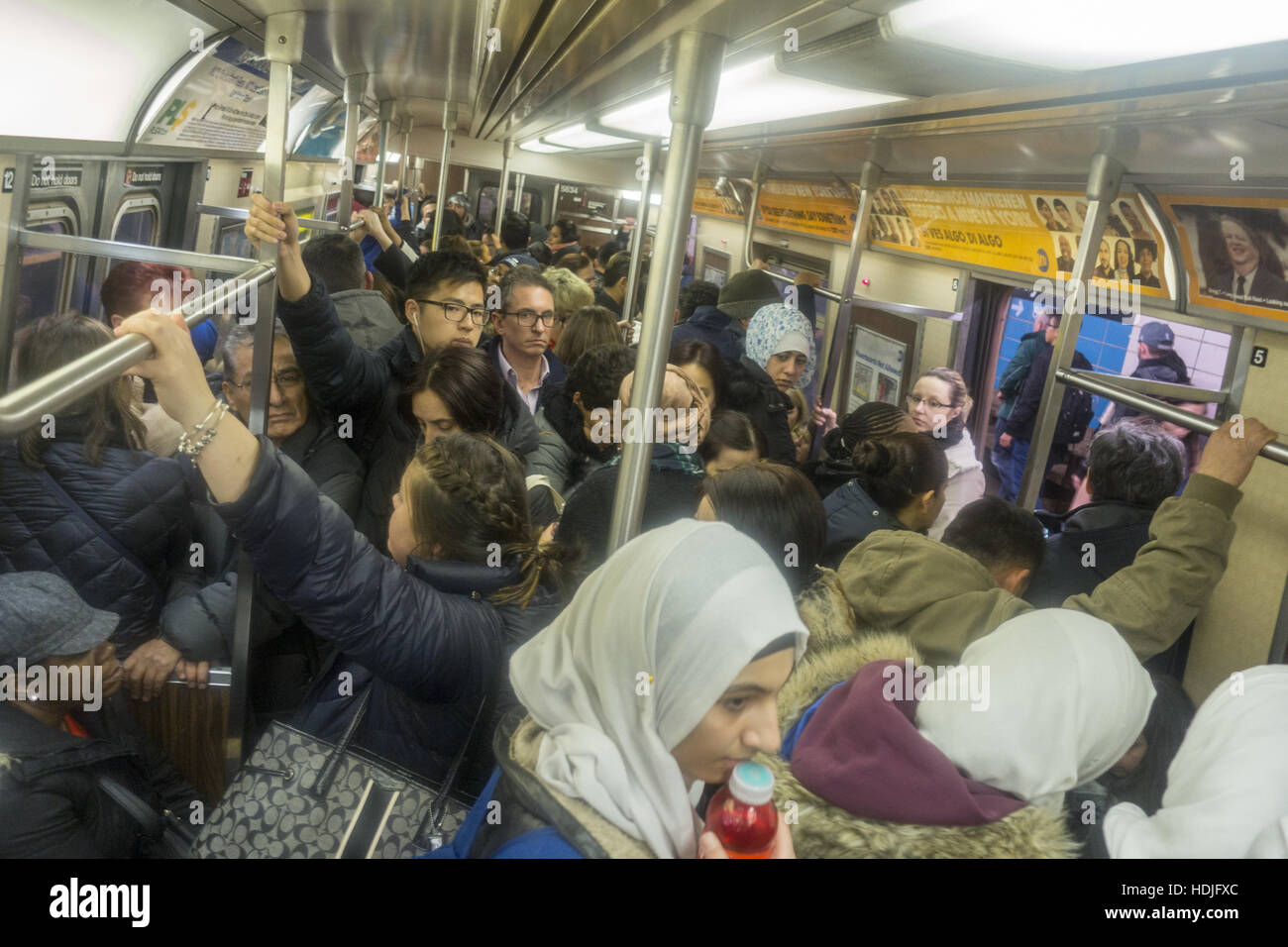 A packed R subway train filled with workers and students in Brooklyn ...