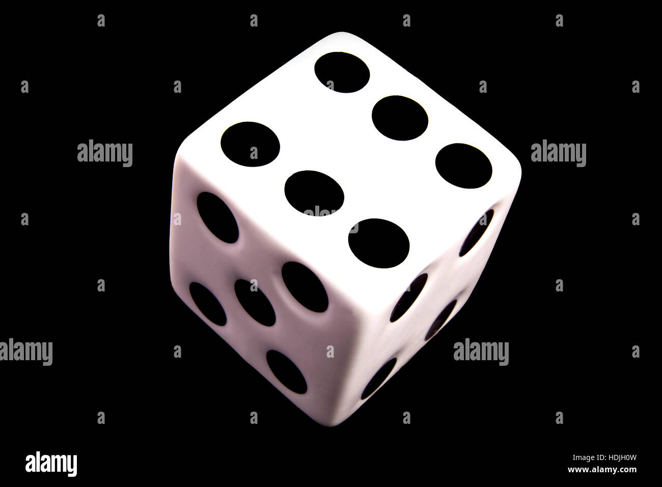 Dice with spots isolated on a black background Stock Photo - Alamy