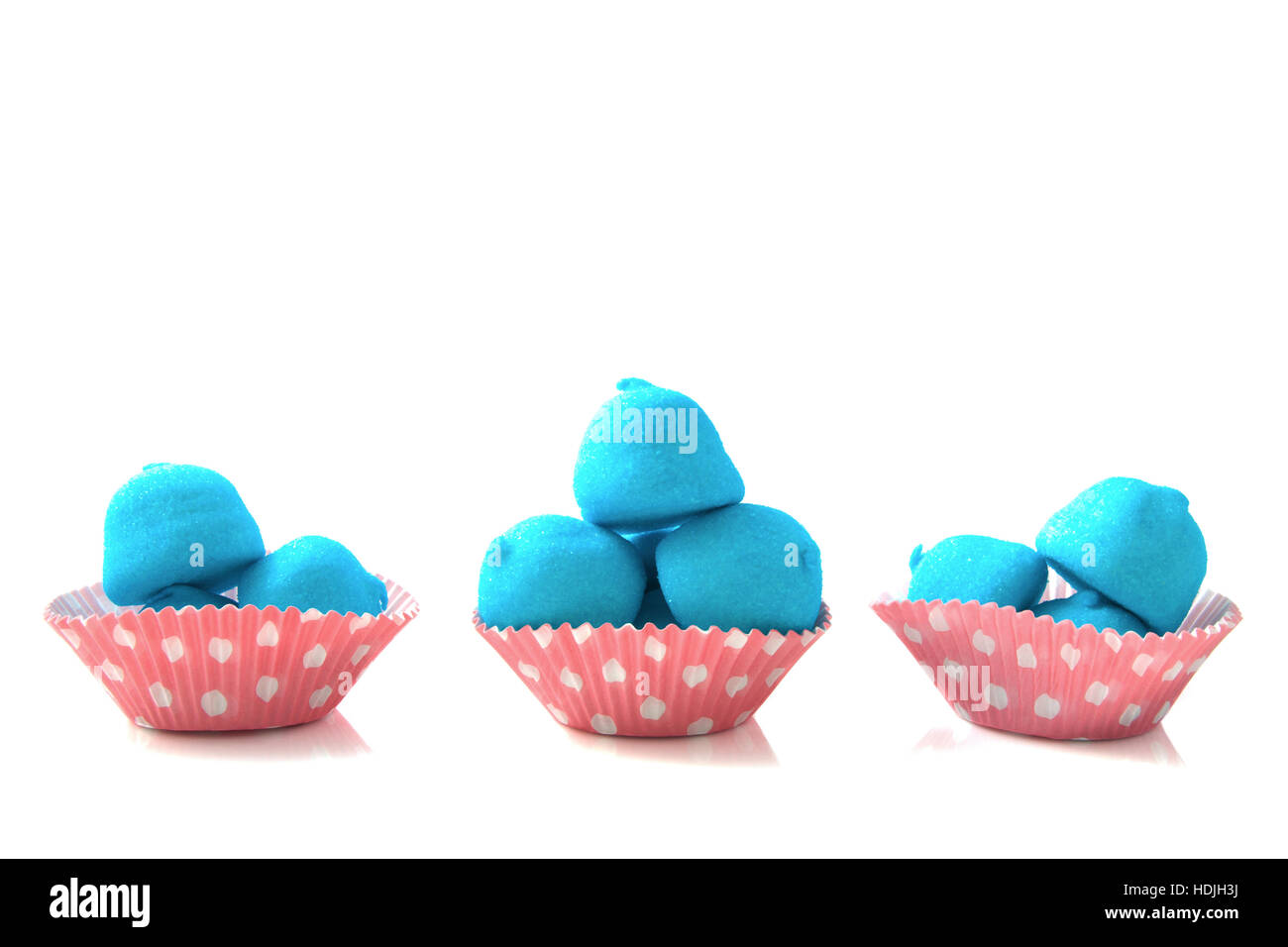 Blue marshmallows in pink white spotted cups isolated over white Stock ...