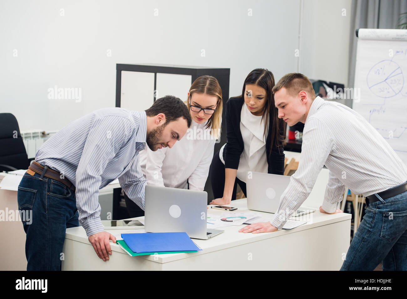 Young business people sitting in office during meeting and discussing ...
