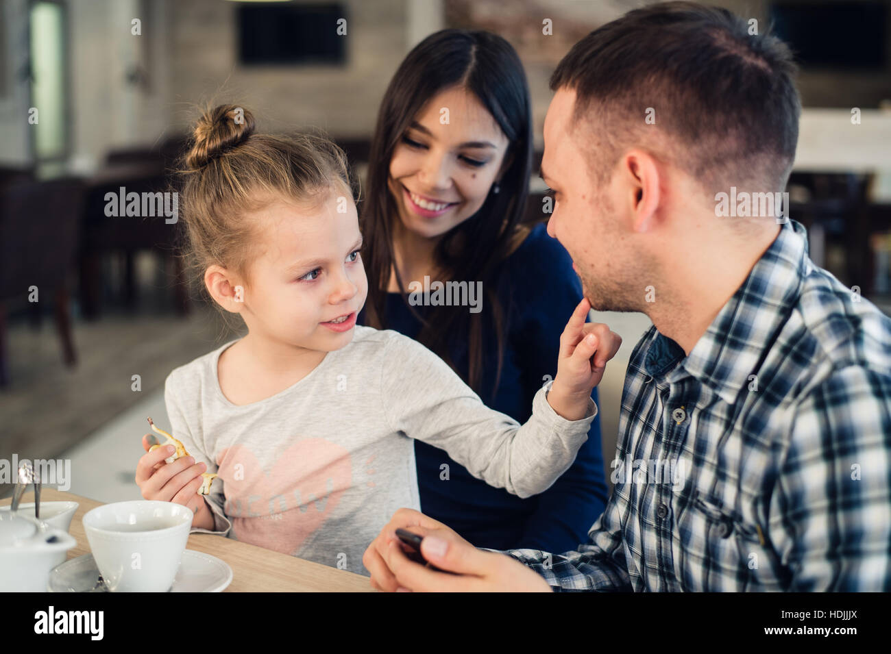 Family Enjoying tea In Cafe Together Stock Photo - Alamy