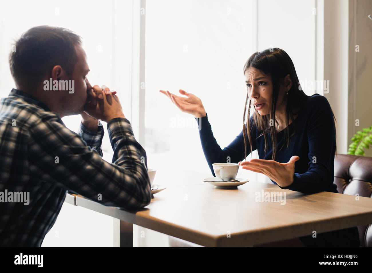 Young couple arguing in a cafe. Relationship problems Stock Photo - Alamy