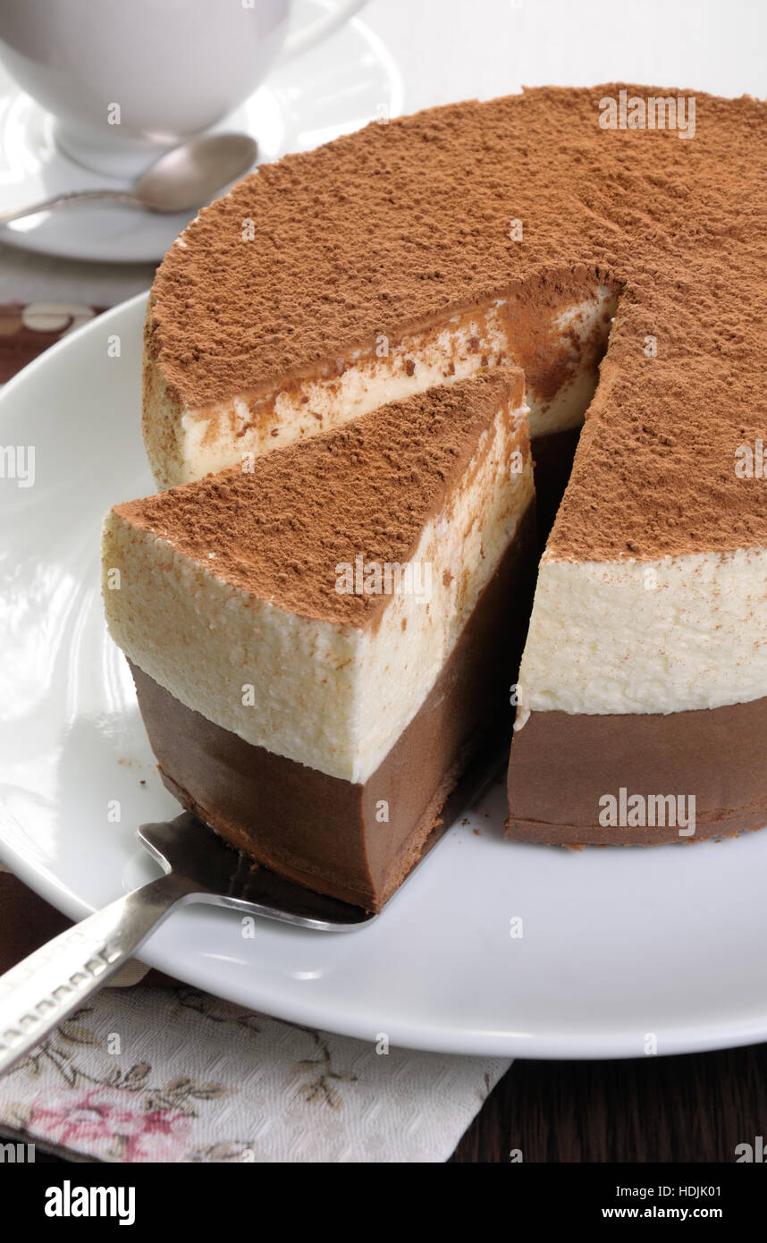 Cut a piece of chocolate with vanilla mousse cake covered cocoa Stock ...