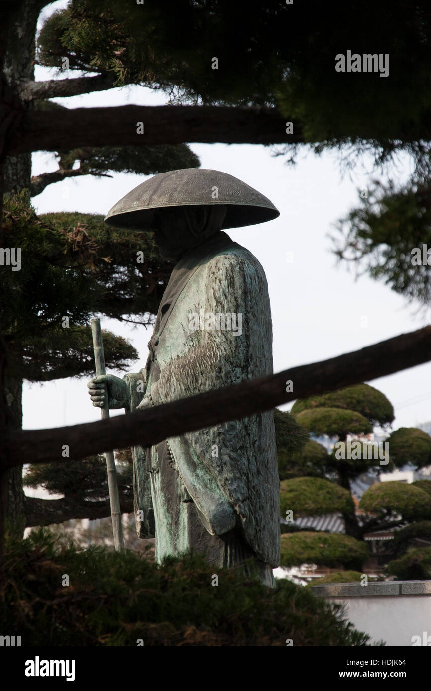 Statue of a monk, surrounded by trees, Daijoki temple, Nagasaki Stock ...