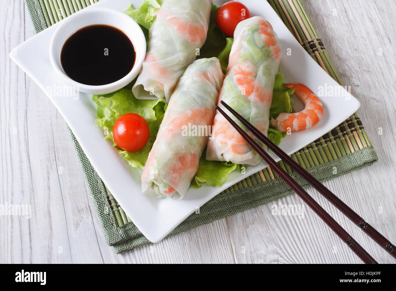 Korean spring rolls with shrimp and sauce on a plate close-up ...