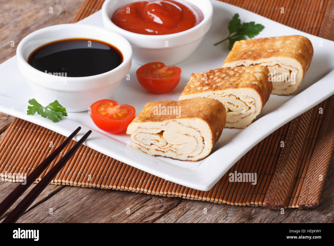 Japanese omelet tamago with sauce on a plate. horizontal Stock Photo ...
