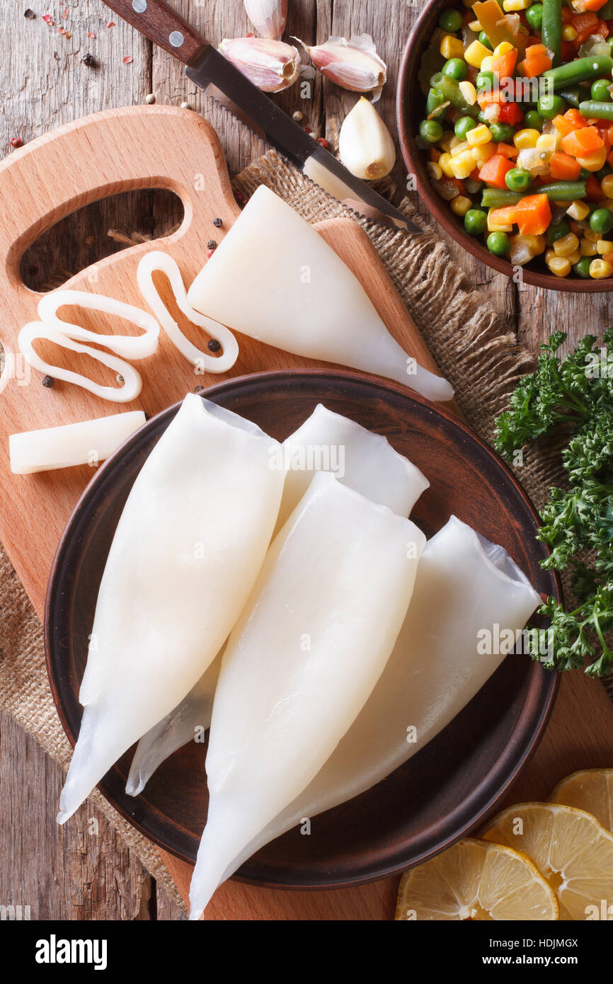 Preparation of raw squid and ingredients on the table. vertical top ...