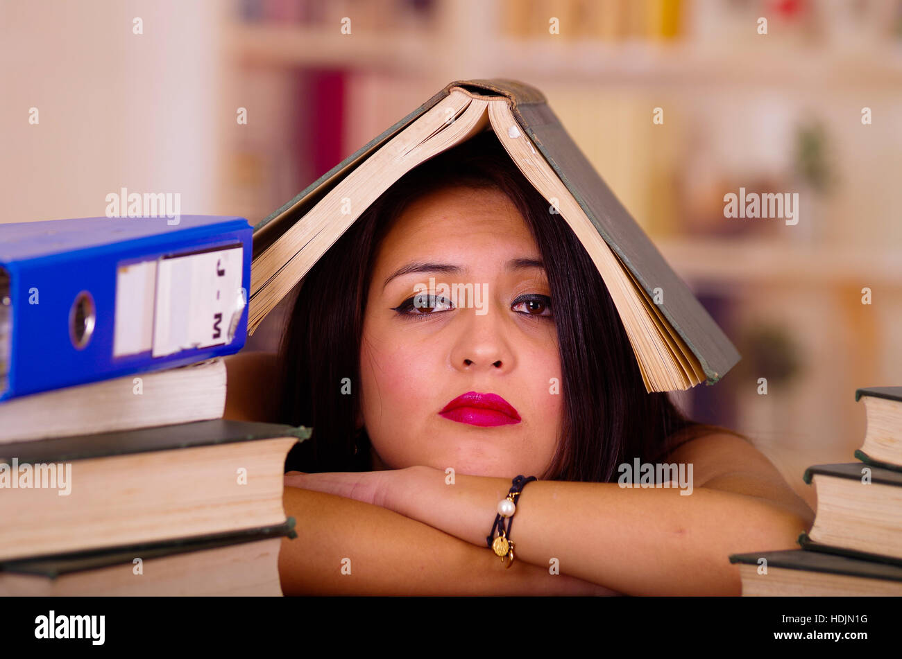 Woman looking over top of book hi-res stock photography and images - Alamy