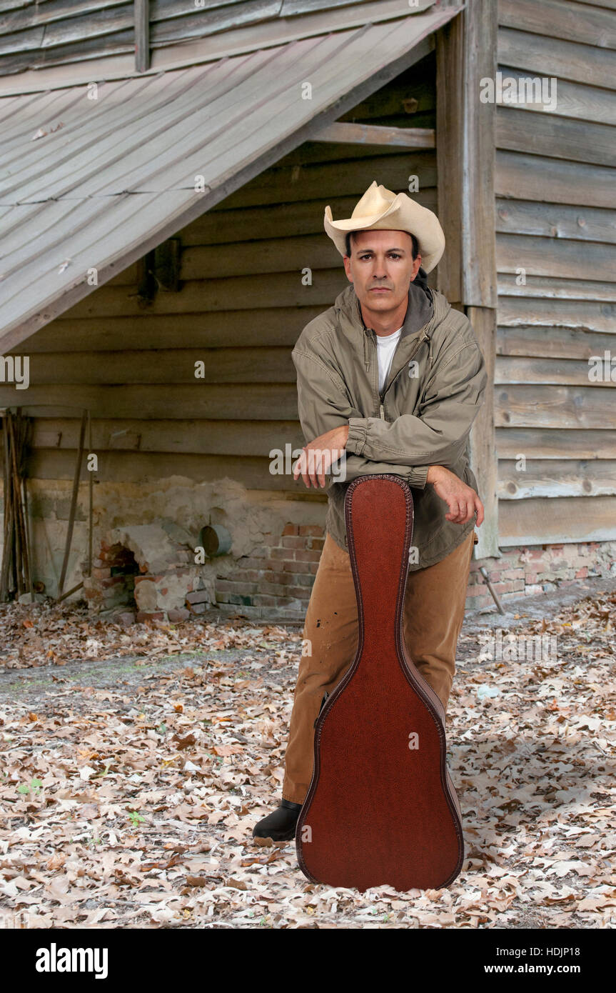 Handsome man country western guitar player performer Stock Photo - Alamy