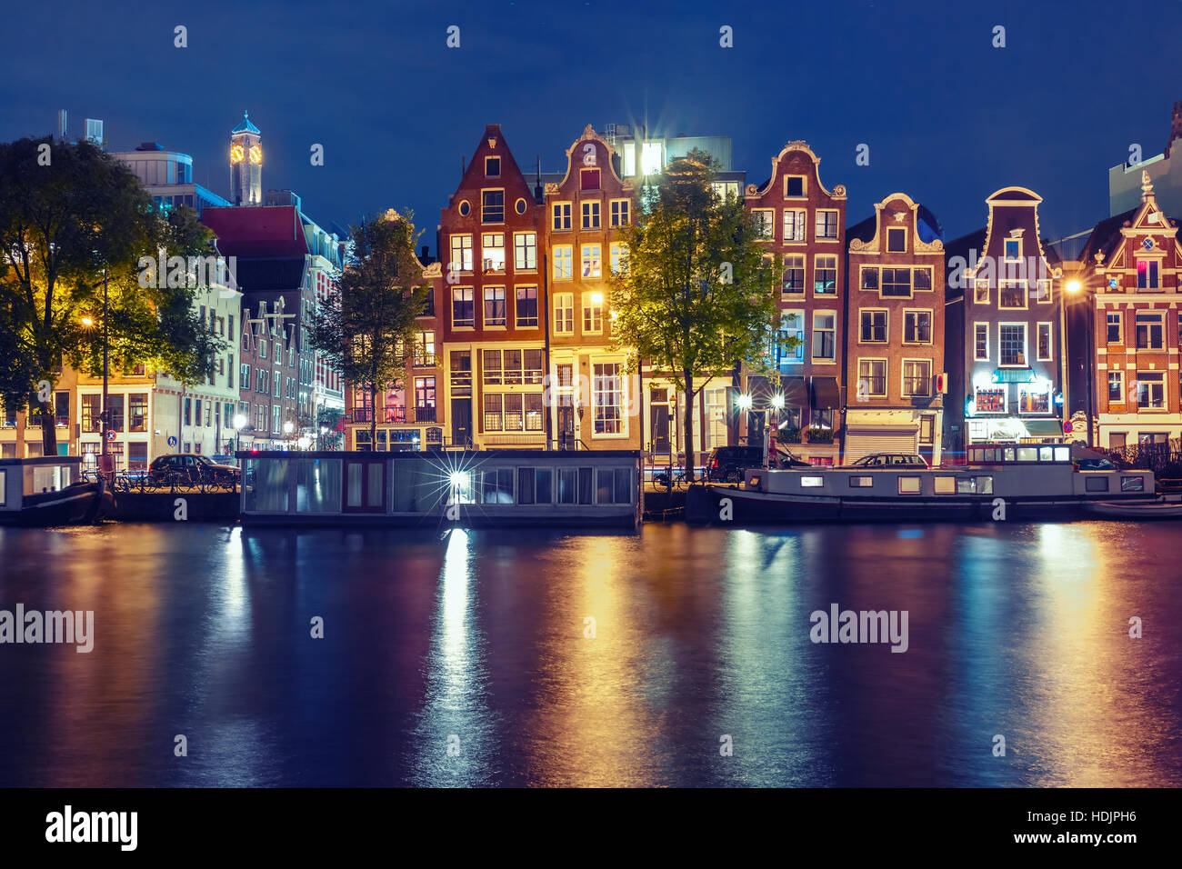 Night city view of Amsterdam canal with dutch houses Stock Photo - Alamy