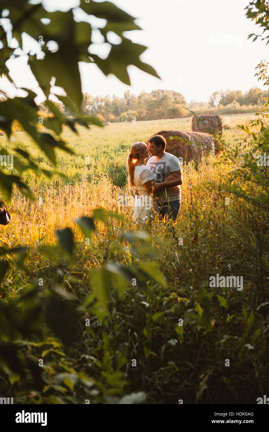 love story man and woman on the background of haystacks and sun Stock ...