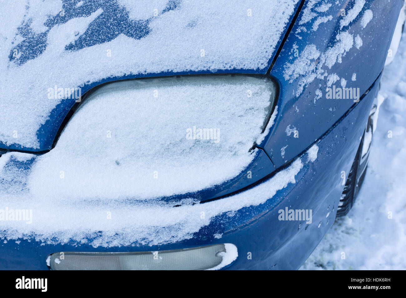 blue car covered with snow during a blizzard Stock Photo - Alamy