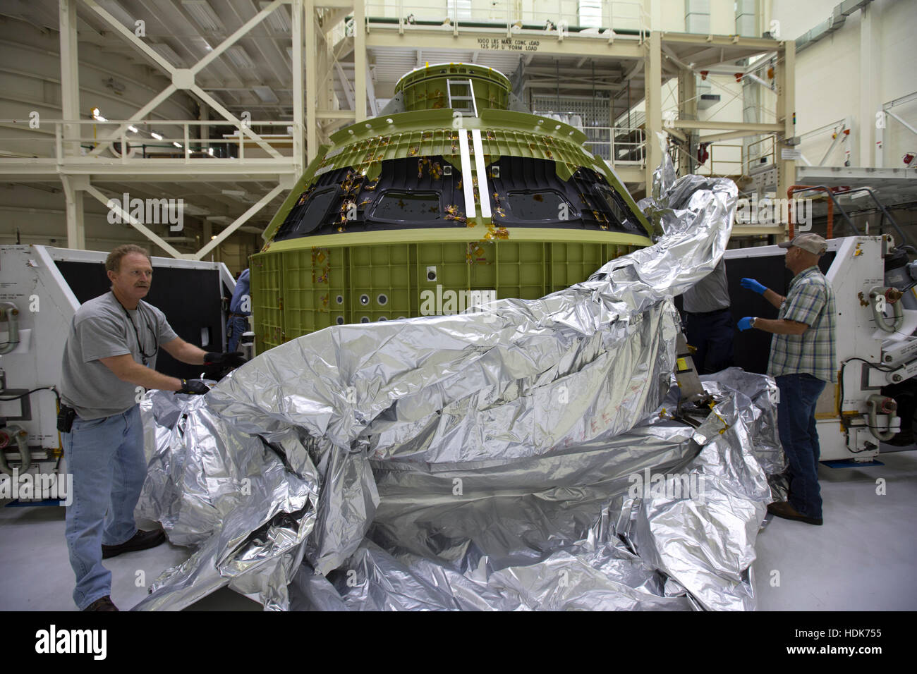 Lockheed Martin technicians remove the protective covering from the ...