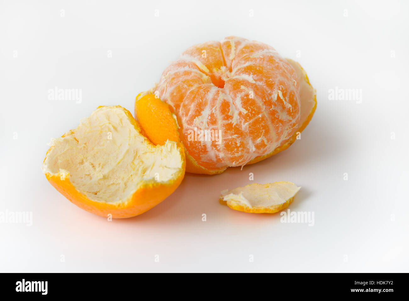 Peeled tangerine is photographed on a white background Stock Photo - Alamy