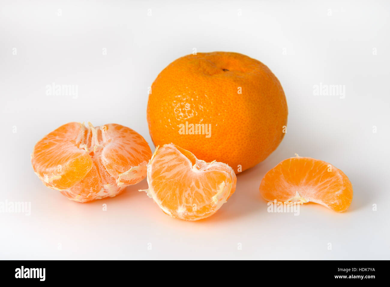 Peeled tangerine is photographed on a white background Stock Photo - Alamy