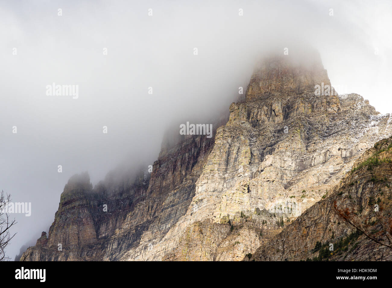 beautiful rocky mountains with colorful layers breaking thru the fog ...