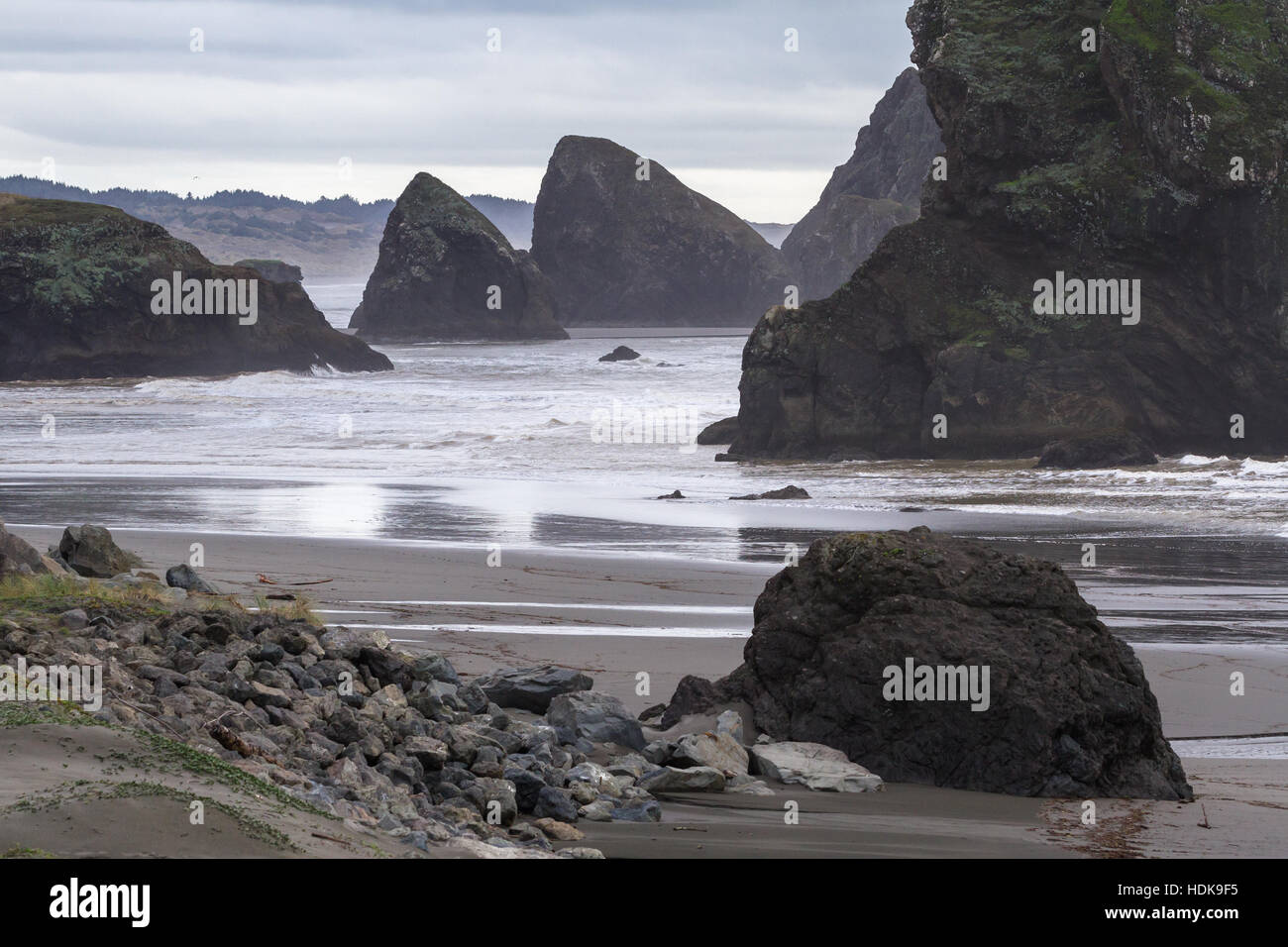 dramatic coastline in the Oregon coast with large boulders on the beach ...