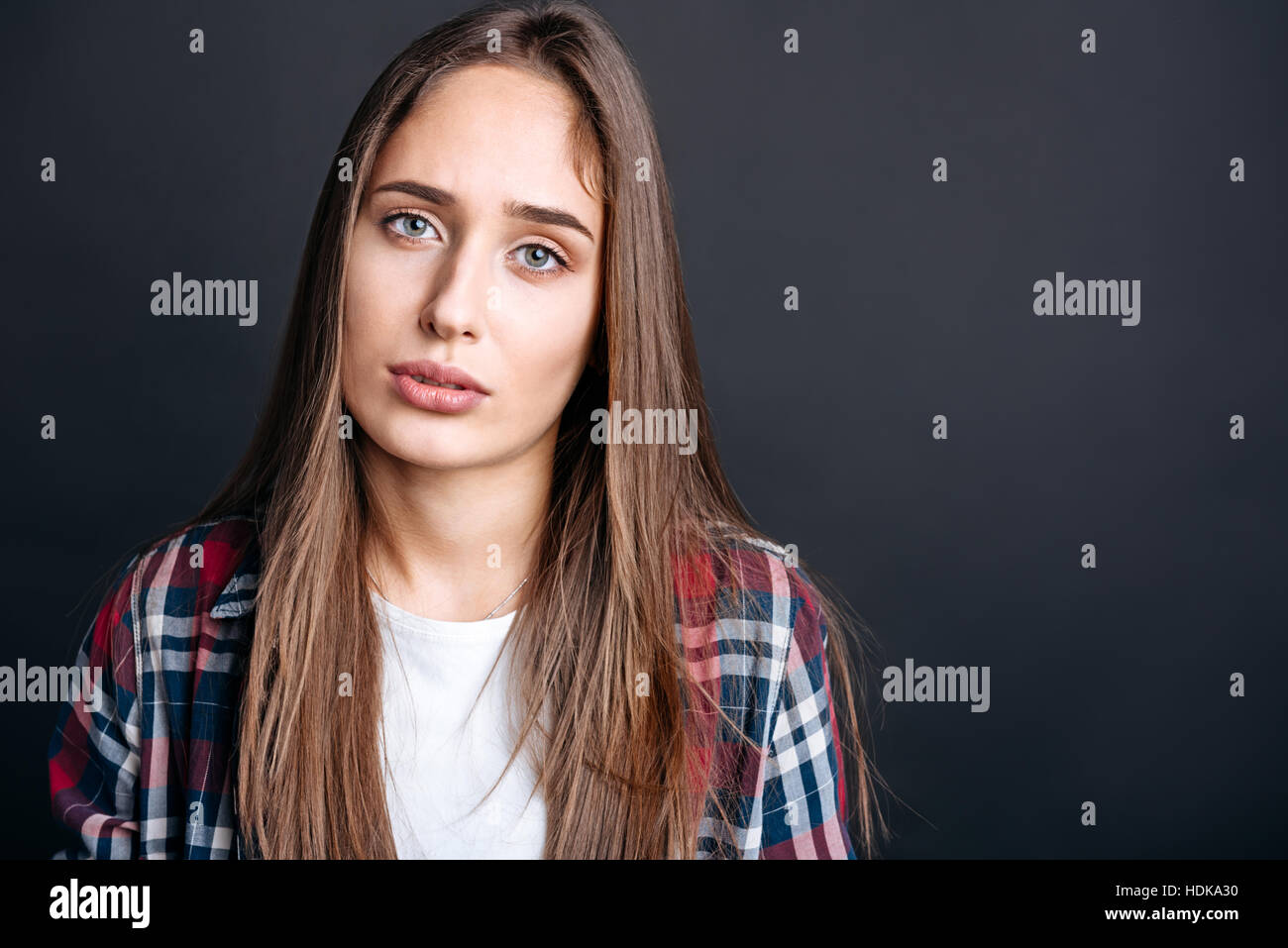 Moody woman standing on black background Stock Photo - Alamy