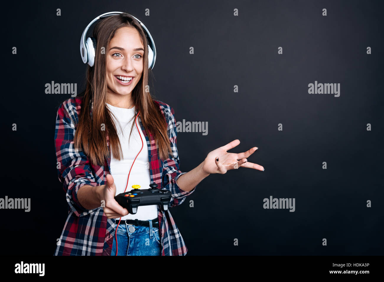 Cheerful smiling girl playing video games Stock Photo - Alamy