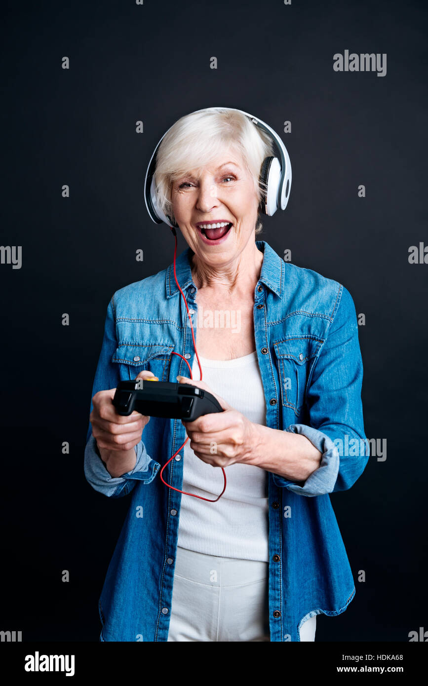Senior woman playing video games hi-res stock photography and images ...