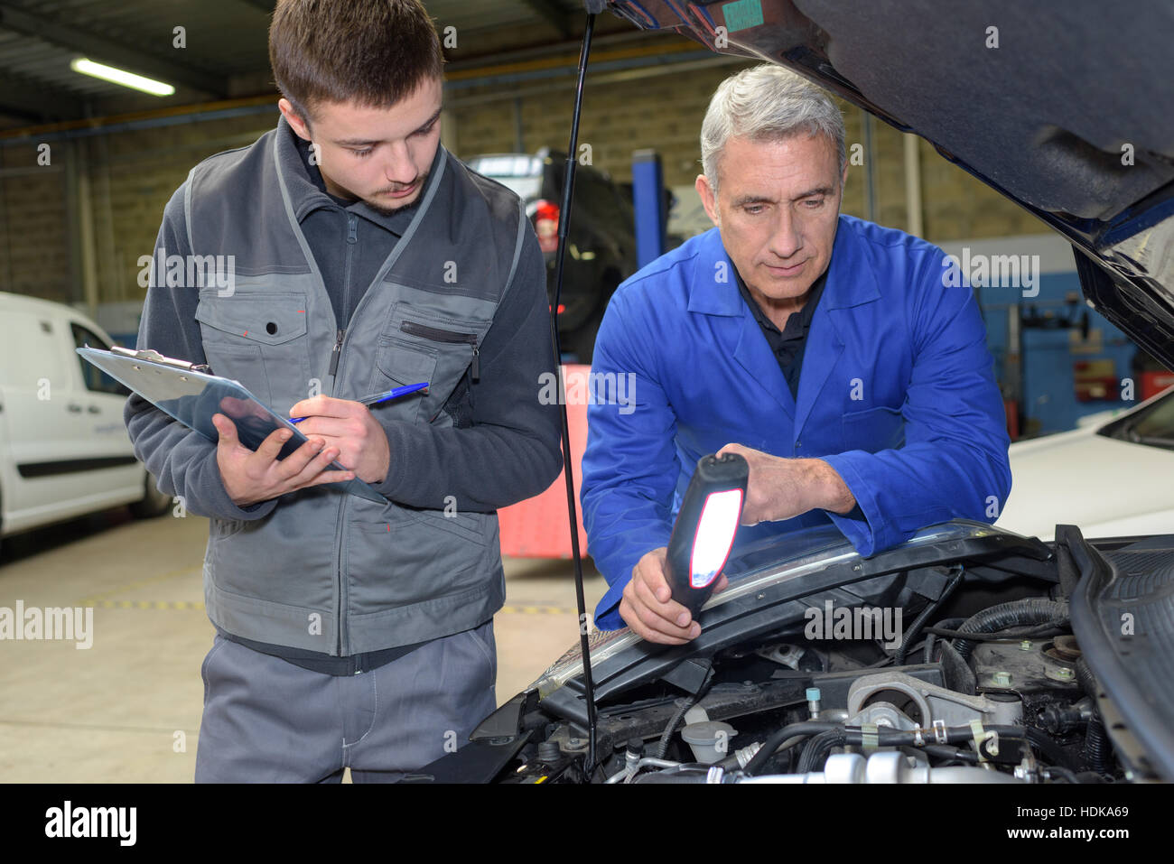 student with instructor repairing a car during apprenticeship Stock ...