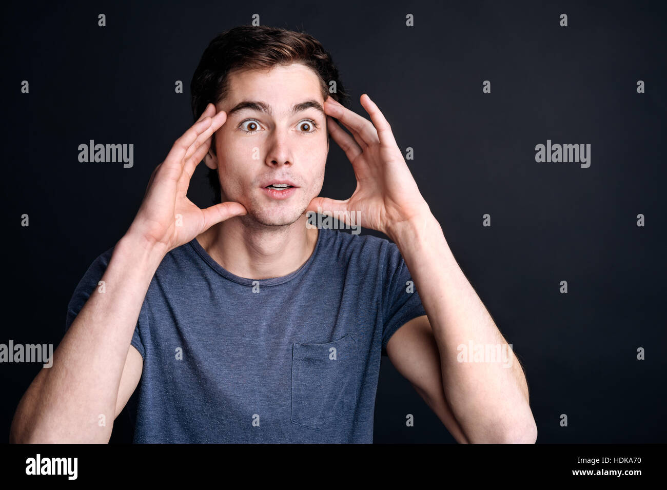 Pleasan young man expressing wonder Stock Photo - Alamy