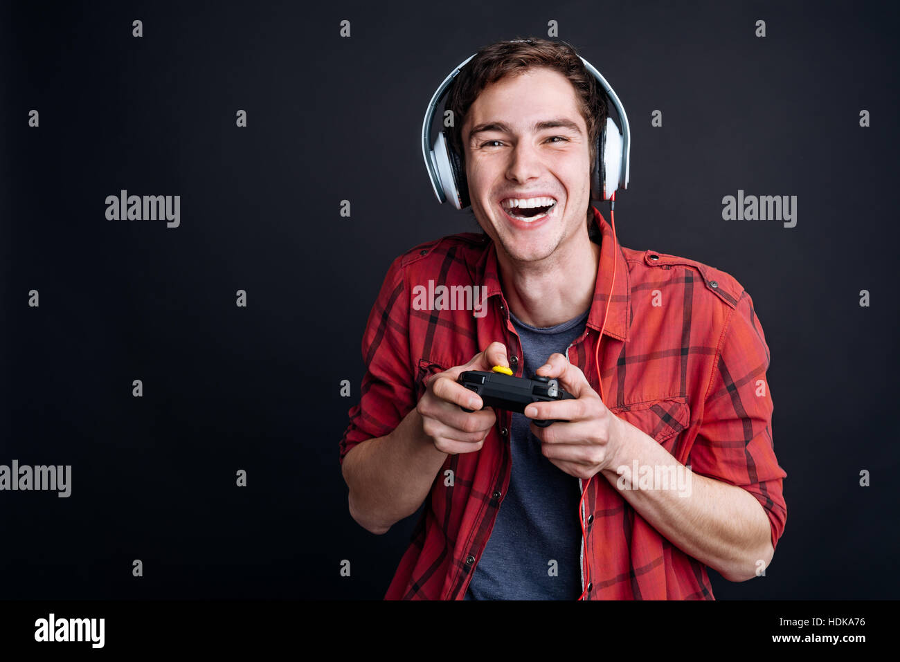 Cheerful young man playing video games Stock Photo - Alamy
