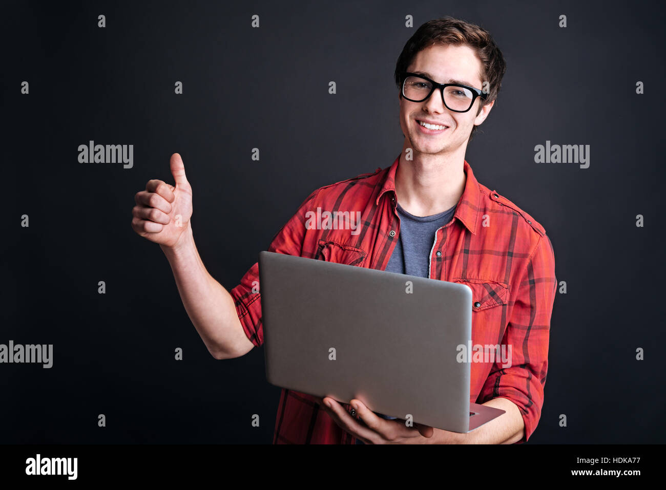 Cheerful student holding laptop Stock Photo - Alamy