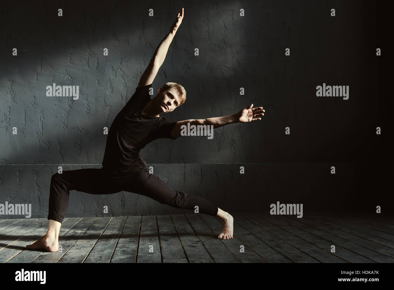 Skillful dancer training in the dark lighted room Stock Photo - Alamy