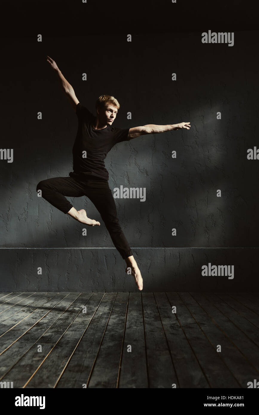 Concentrated young dancer performing the split in the air Stock Photo ...