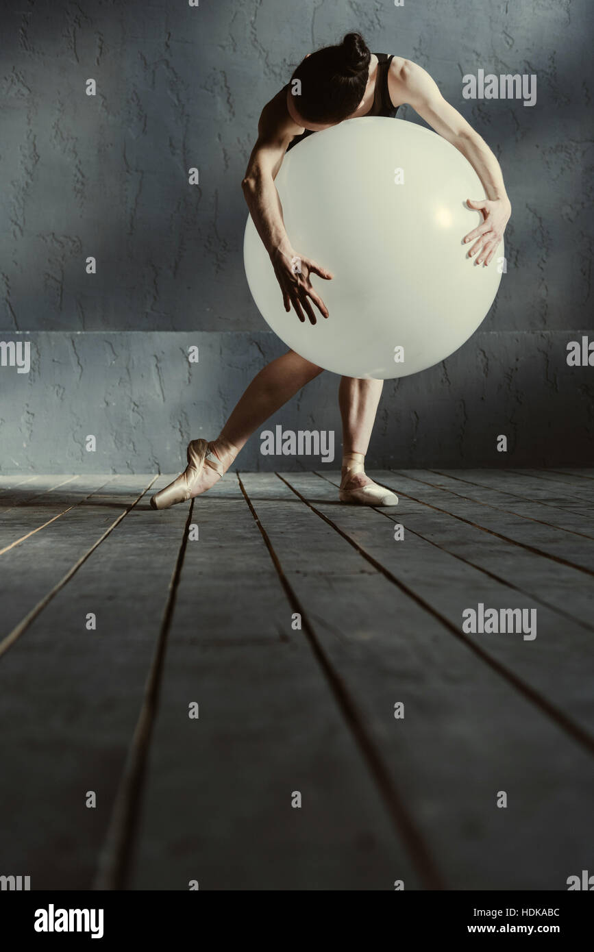 Flexible woman dancing using the white balloon Stock Photo - Alamy