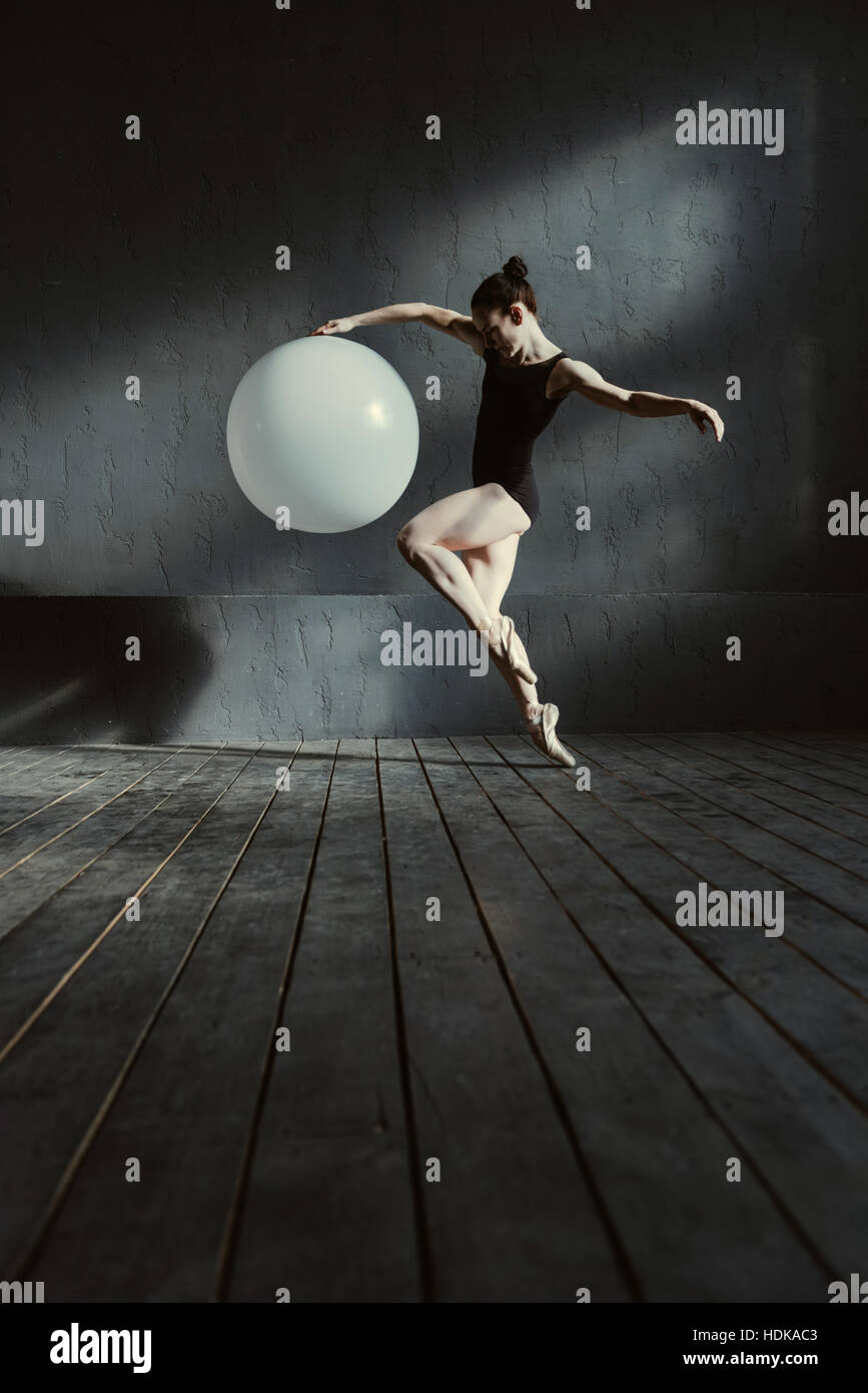 Proficient gymnast stretching using the white balloon Stock Photo - Alamy