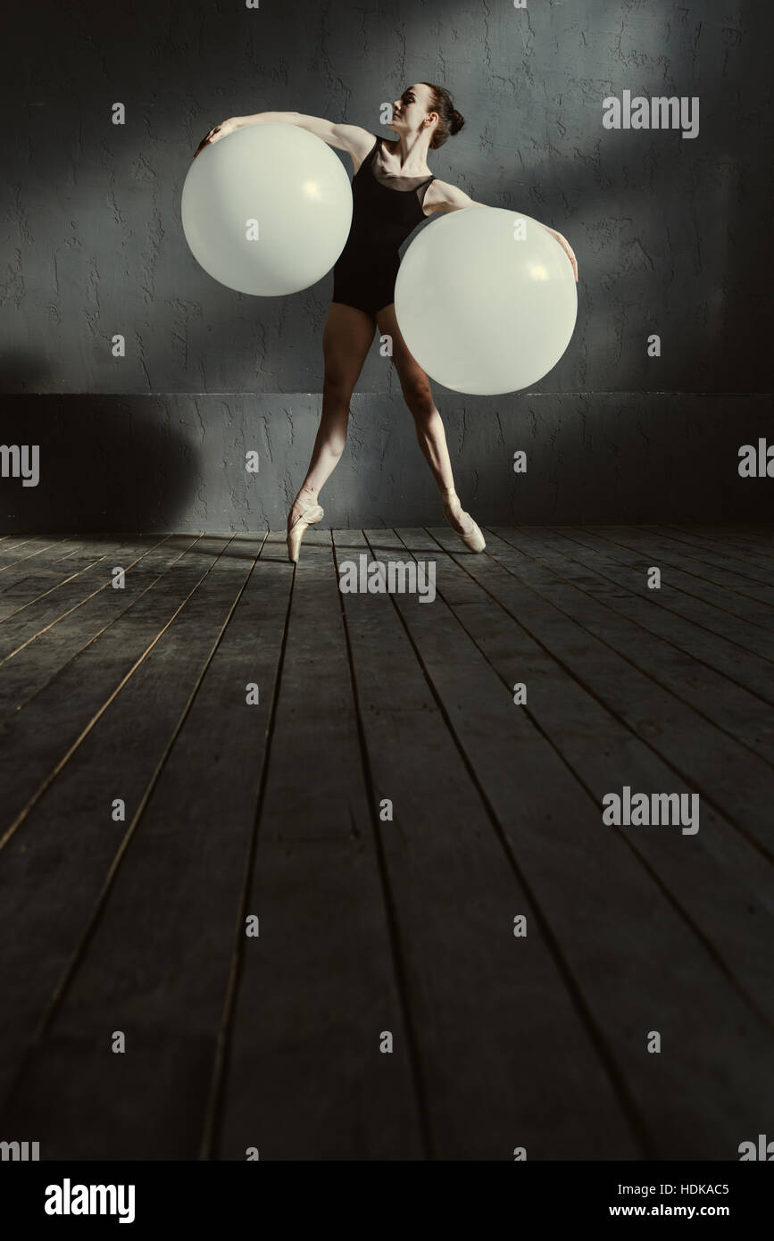 Graceful gymnast dancing using white balls Stock Photo - Alamy