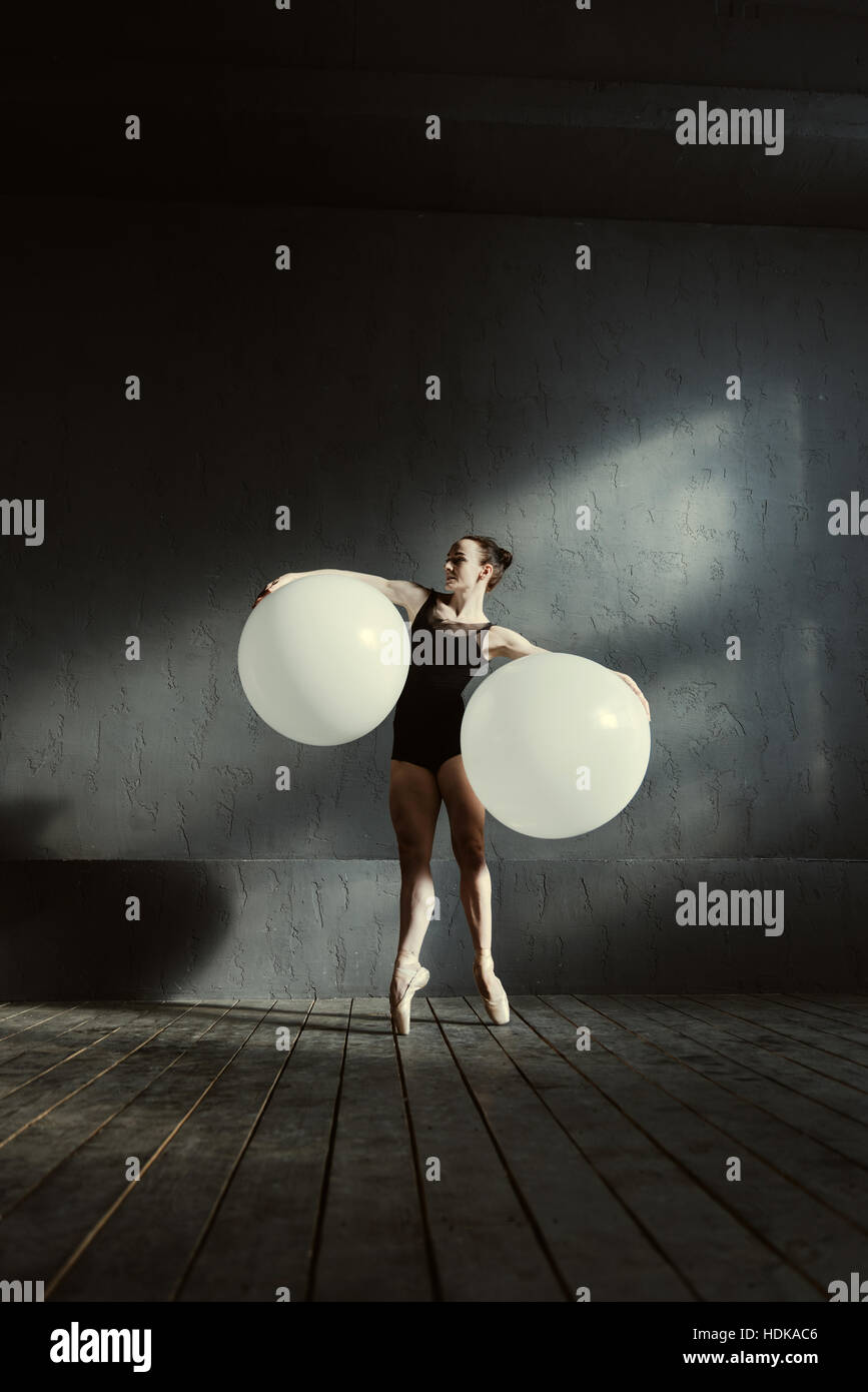 Positive smiling gymnast stretching using white balls Stock Photo - Alamy