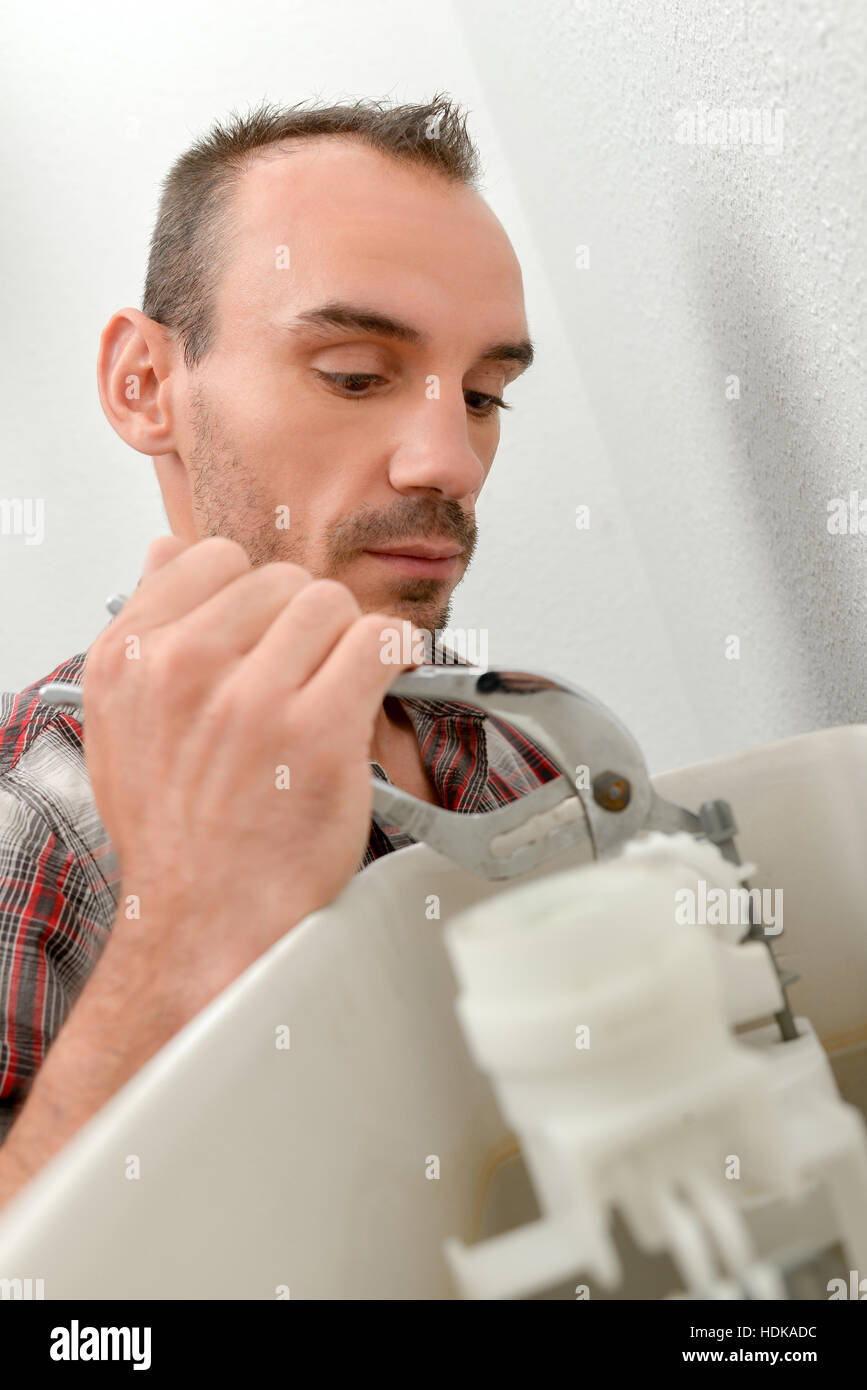Fixing a toilet Stock Photo - Alamy