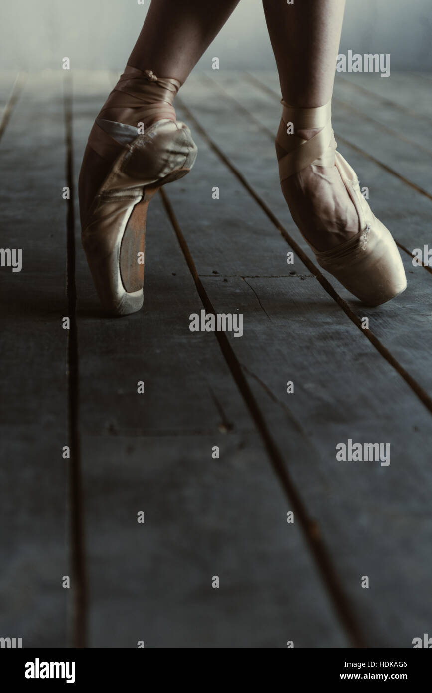 Ballet dancer stretching on tiptoes in the black studio Stock Photo - Alamy
