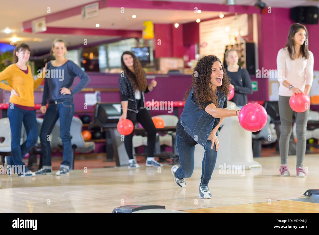 Lady launching bowling ball Stock Photo - Alamy