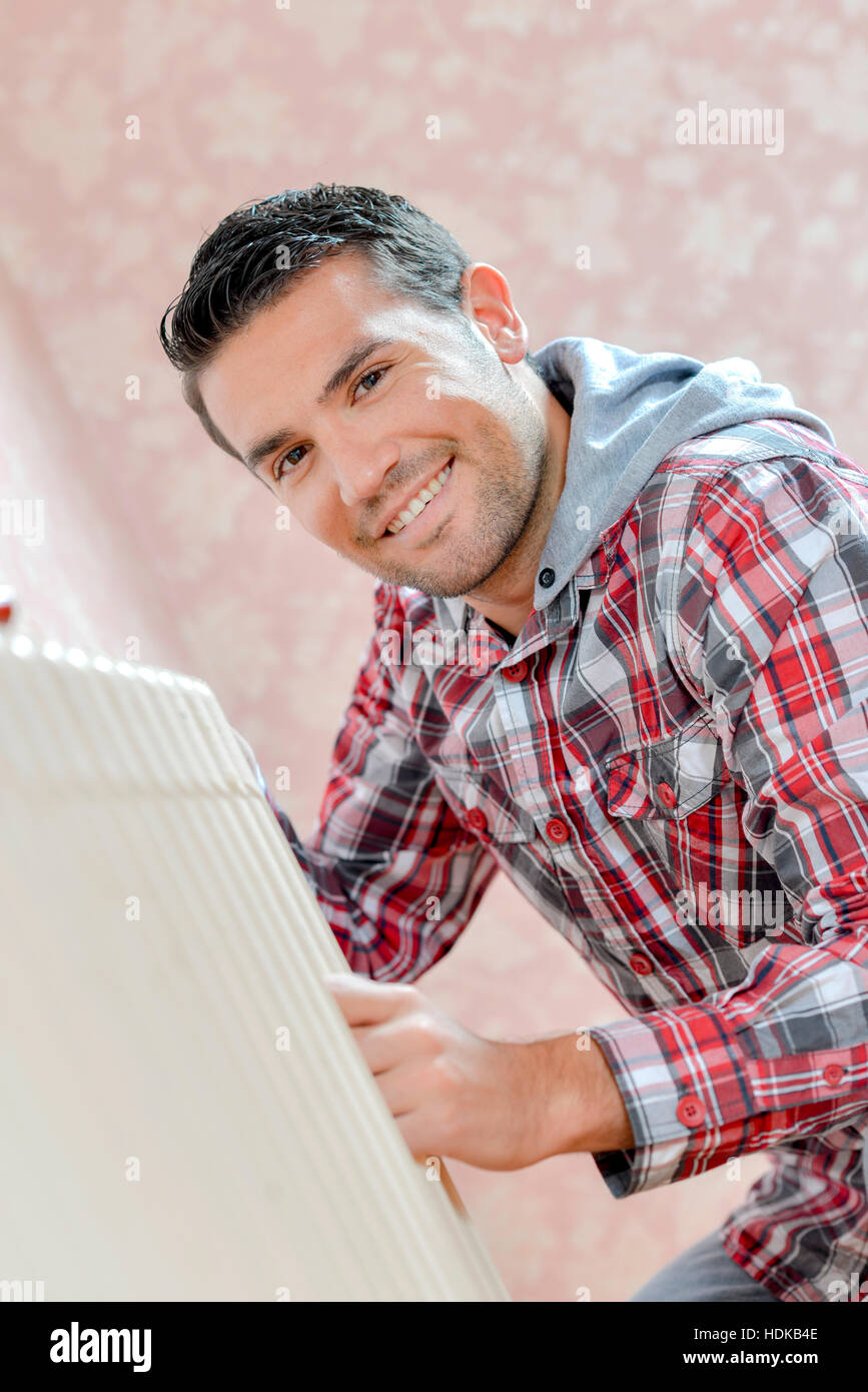man fixing radiator Stock Photo - Alamy