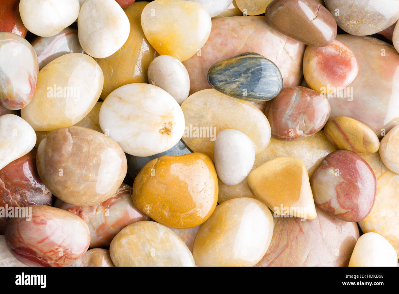 Close up view of several polished colorful river stones as background ...