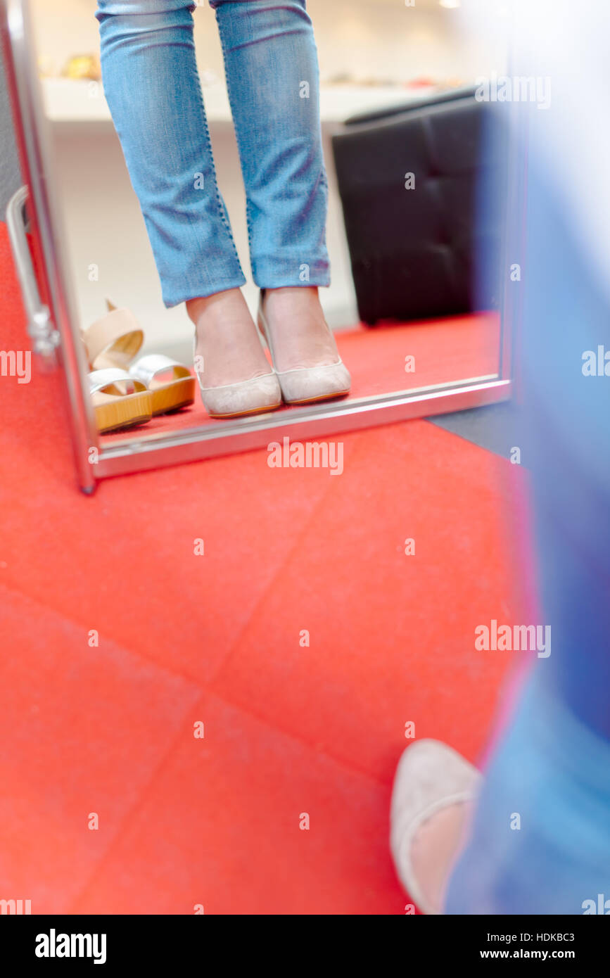 Trying on shoes in a mirror Stock Photo - Alamy