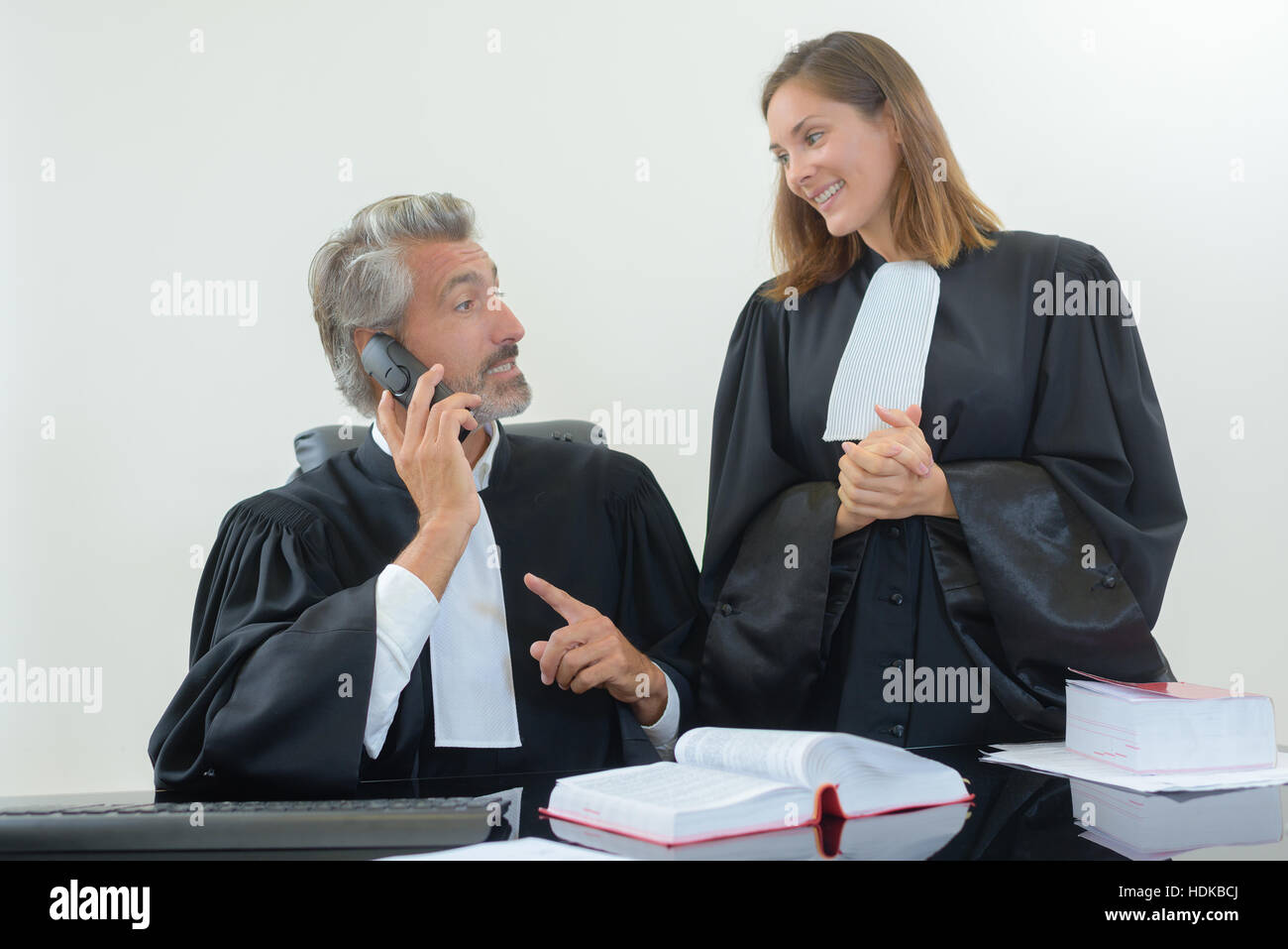 Two judges, one on telephone Stock Photo - Alamy