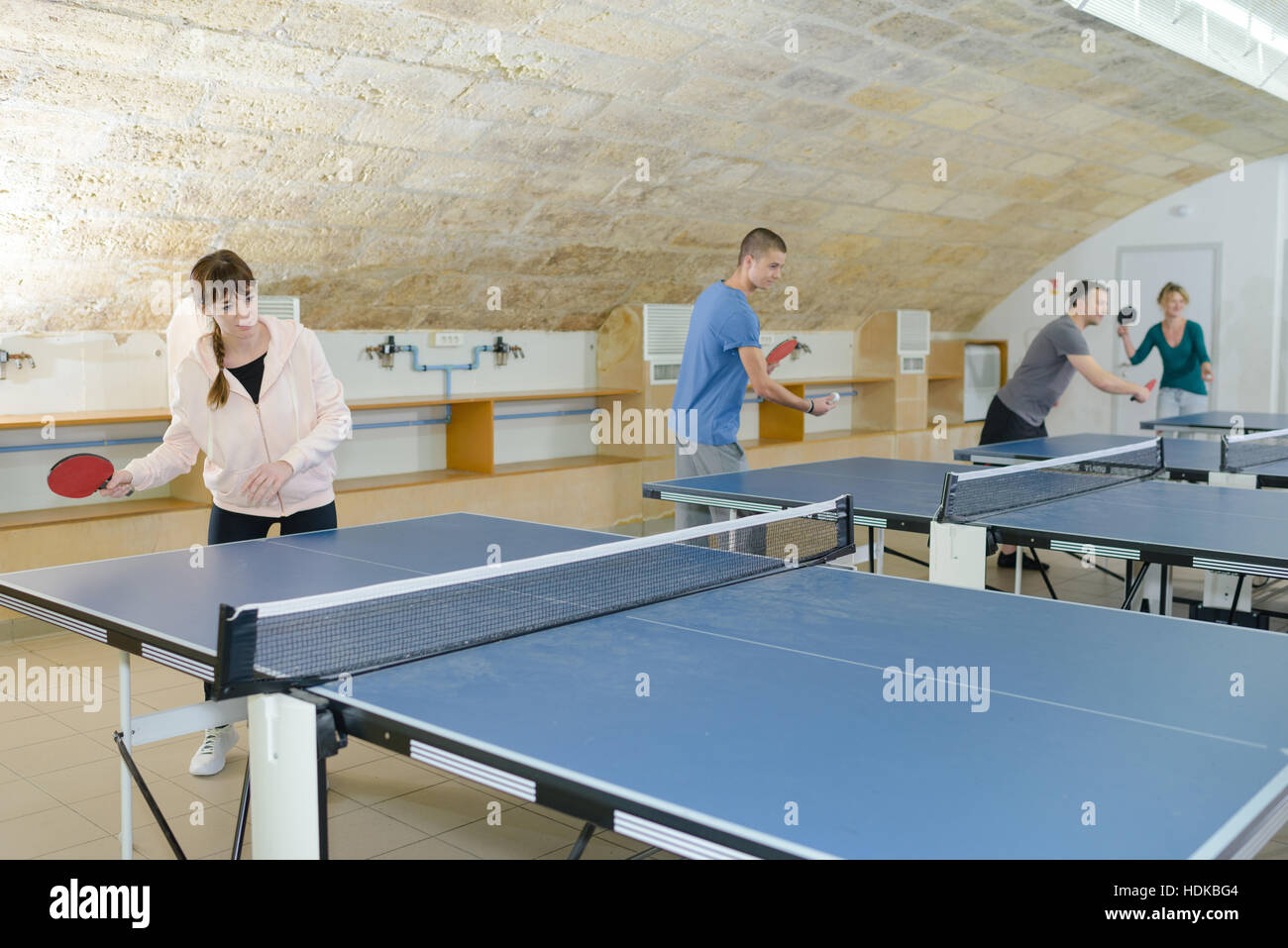 pretty woman playing ping-pong with friends Stock Photo - Alamy