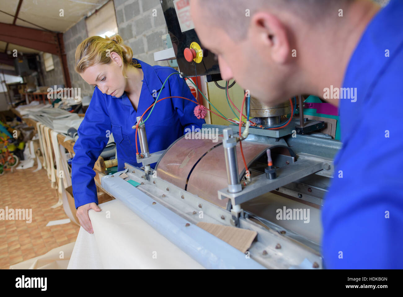 Man and woman using industrial machine Stock Photo - Alamy