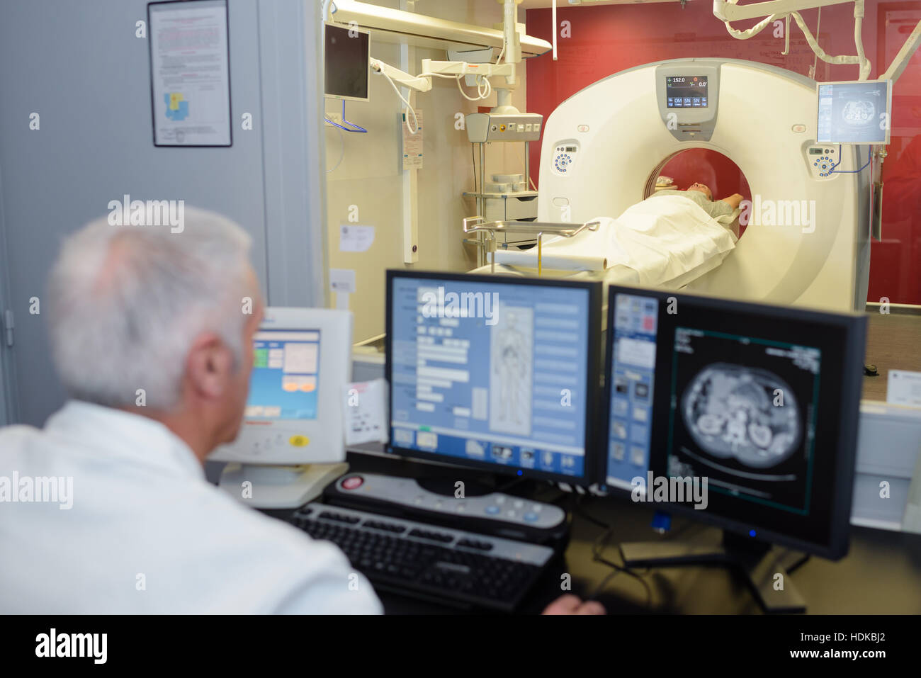 Doctor monitoring patient having scan Stock Photo - Alamy